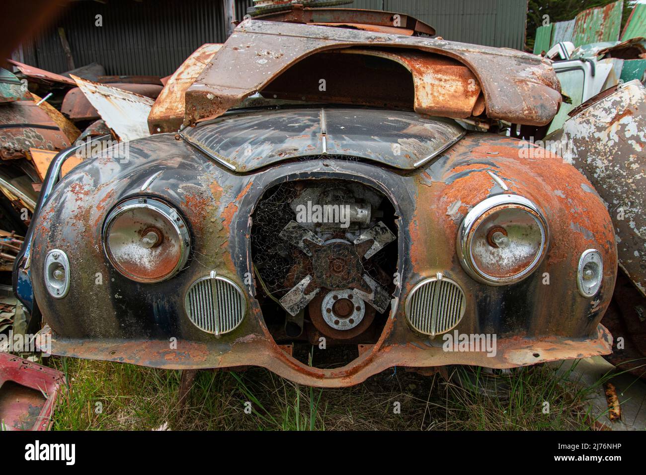Antique cars on a big scrapyard at the end of Old Coach Road Trail ...