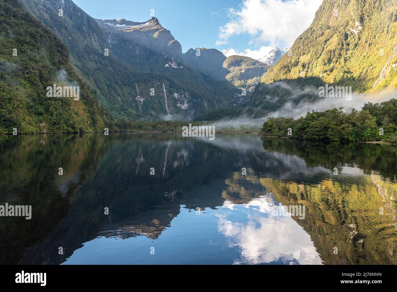 A new morning dawning at Doutful Sound, clouds hanging low in the ...