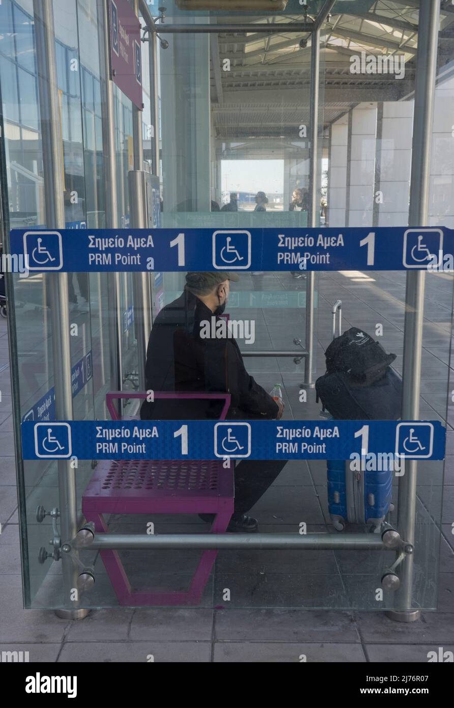 Passengers at a bus stop outside Eleftherios Venizelos Athens ...
