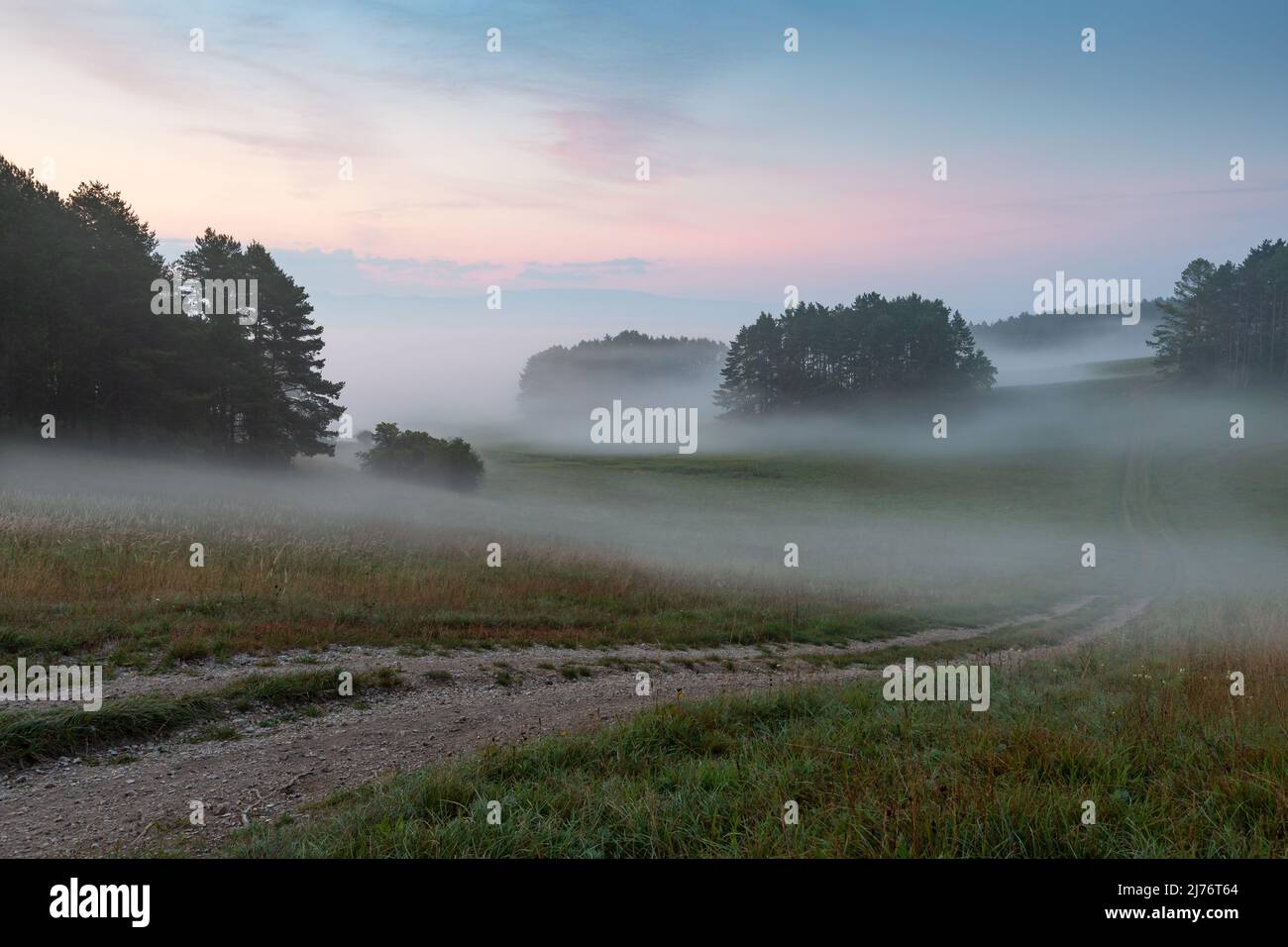 Rural landscape at Ondrasova village shrouded in morning mist, Slovakia ...