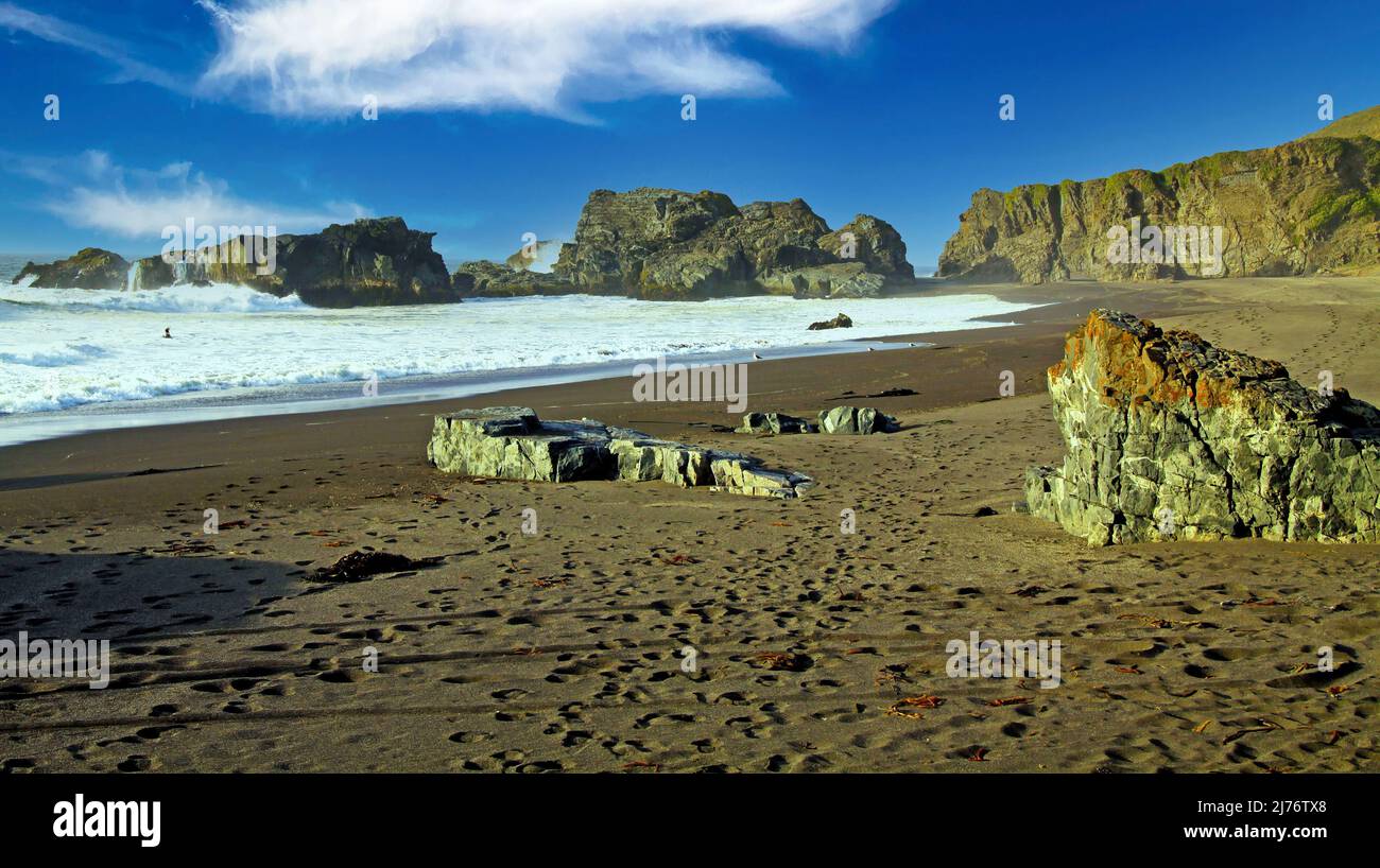 Beautiful scenic secluded black lava sand beach bay, stone rocks,blue ...