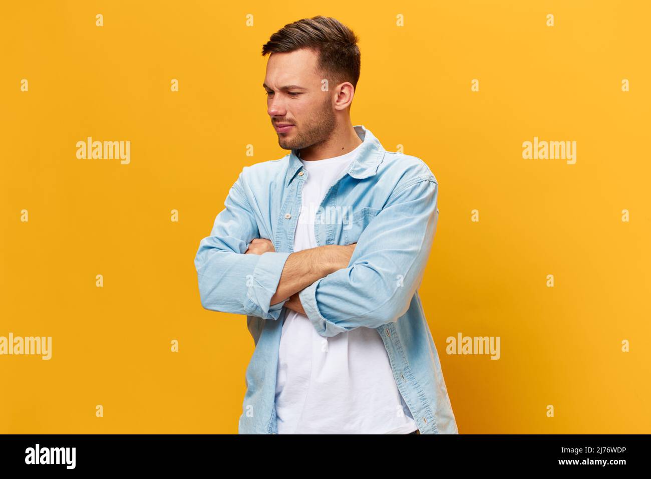 Sad frustrated tanned handsome man in blue basic t-shirt think about ...