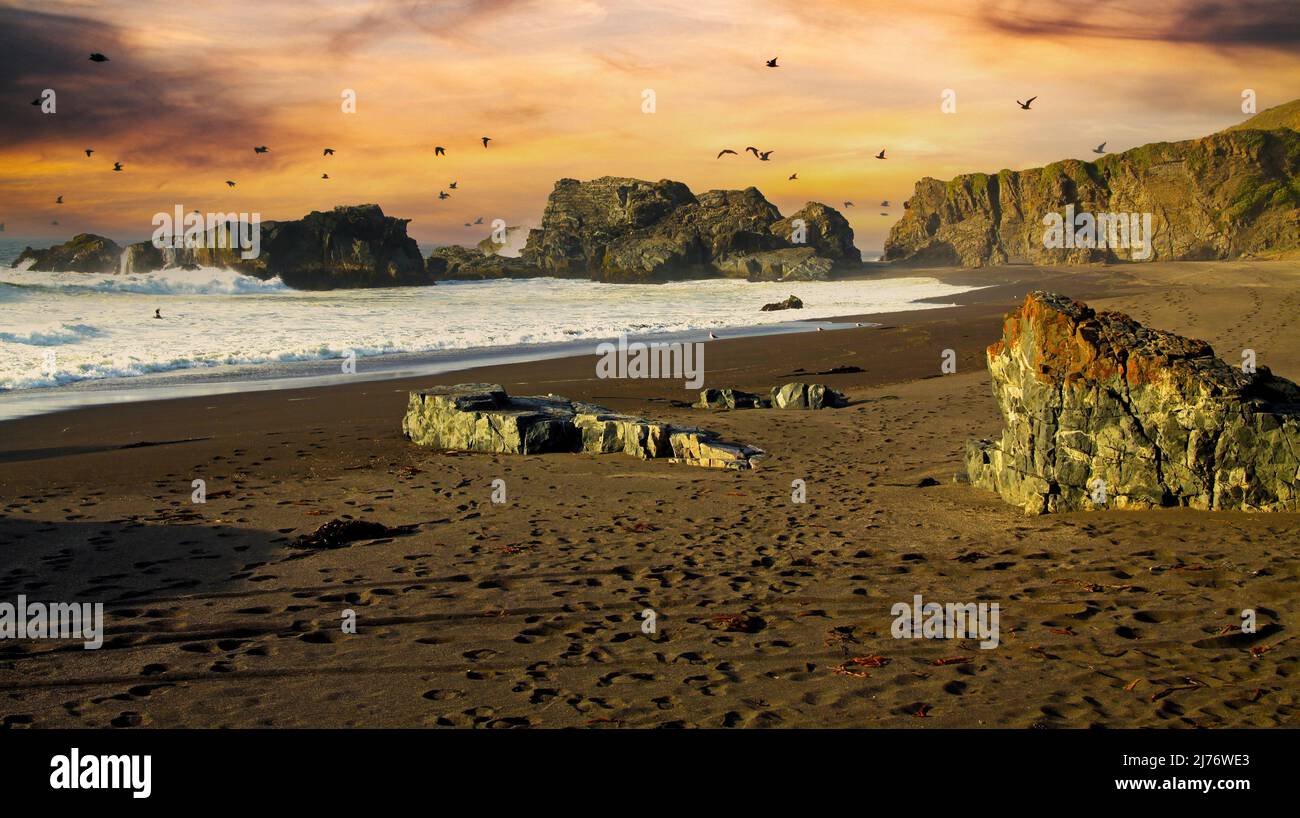 Beautiful scenic secluded black lava sand beach bay, stone rocks, red ...
