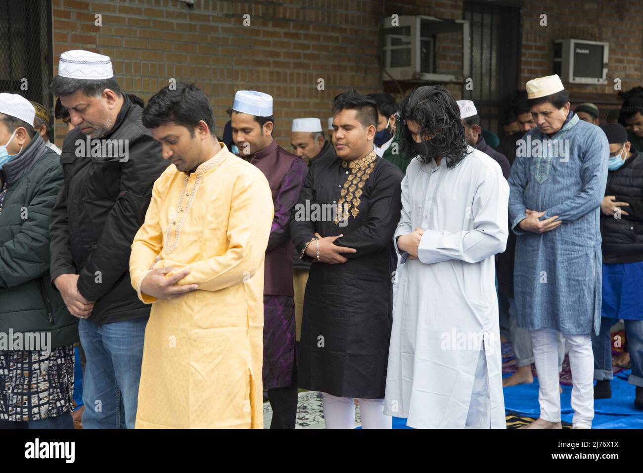 Muslim men pray on Eid outside a Brooklyn, NY mosque in the "Little ...