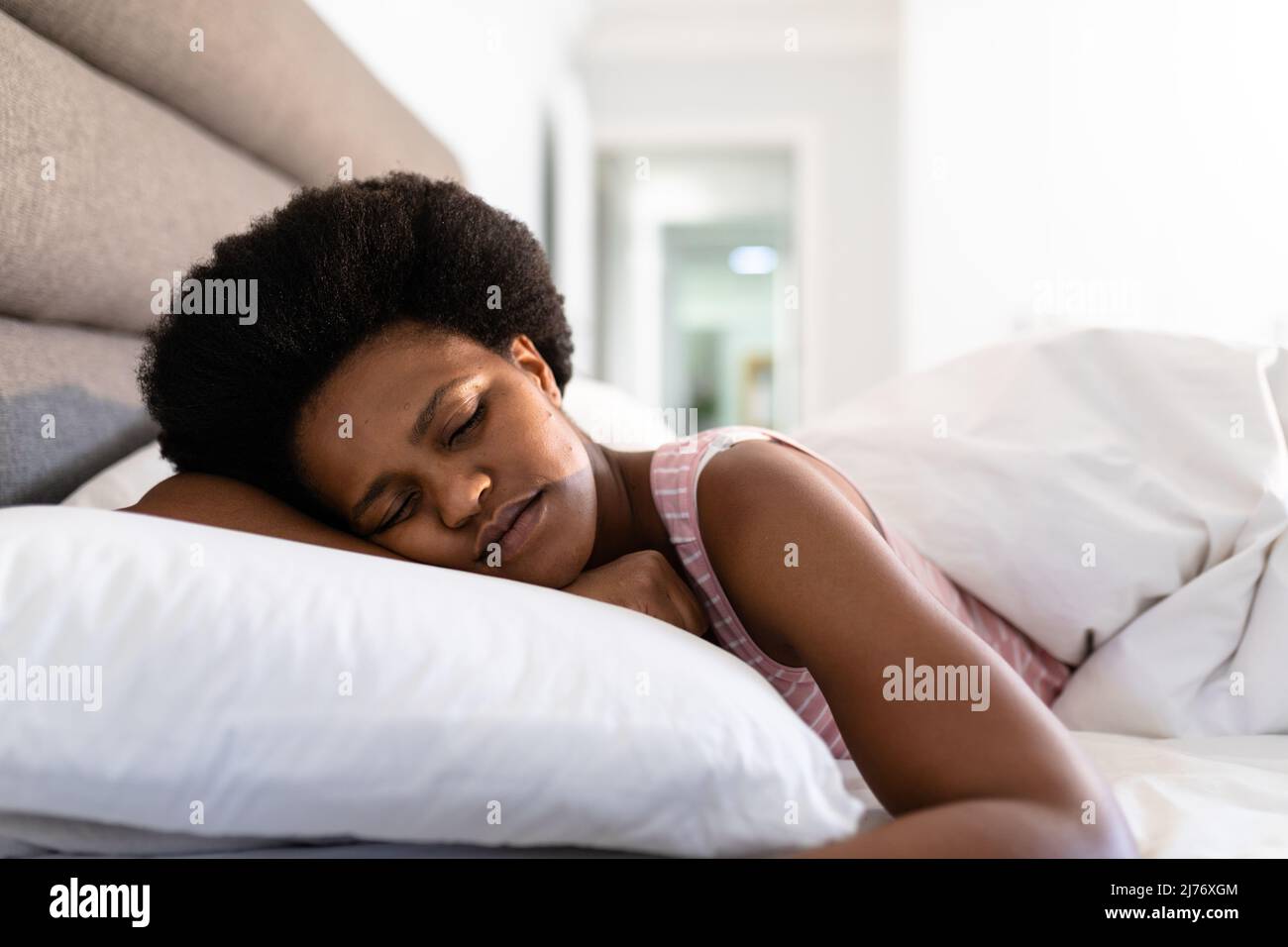 Mid adult african american woman sleeping on bed at home Stock Photo ...