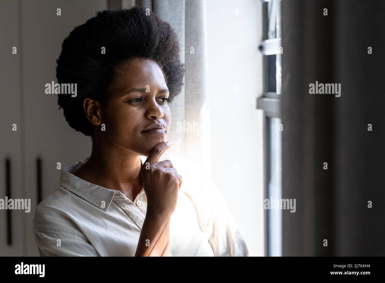Attractive woman sitting home hand chin hi-res stock photography and ...