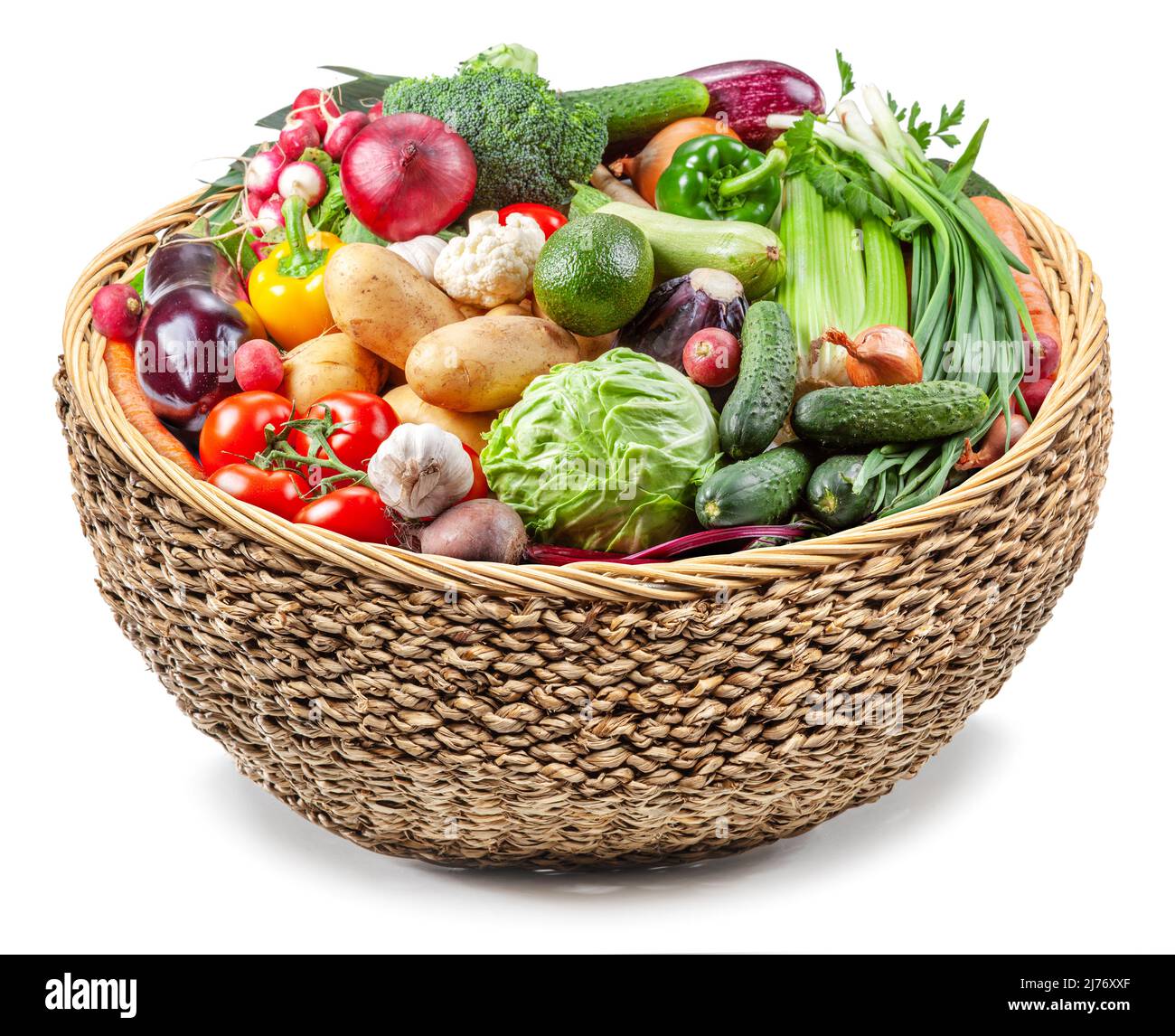Food basket. Vast of different vegetables in the wicker basket on white ...