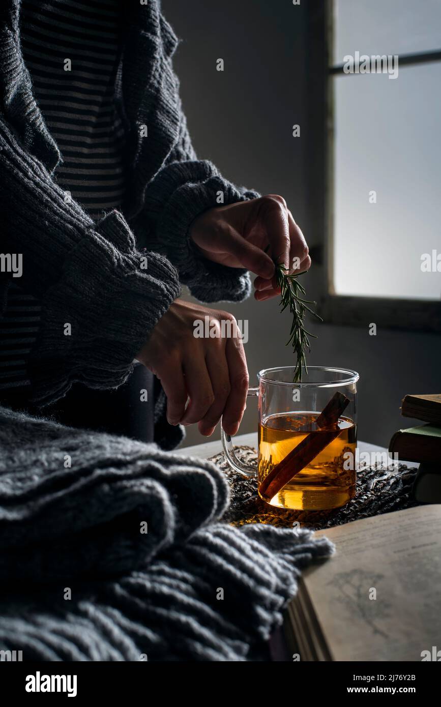 Preparation of a hot infusion with herbs and cinnamon Stock Photo - Alamy