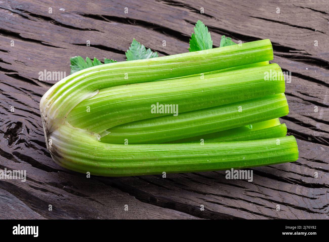 Pile of celery ribs on green wooden table. Healthy food background ...