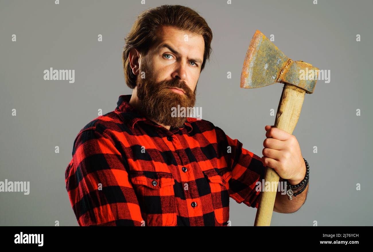 Serious man with axe. Bearded lumberjack with ax. Male in checkered ...