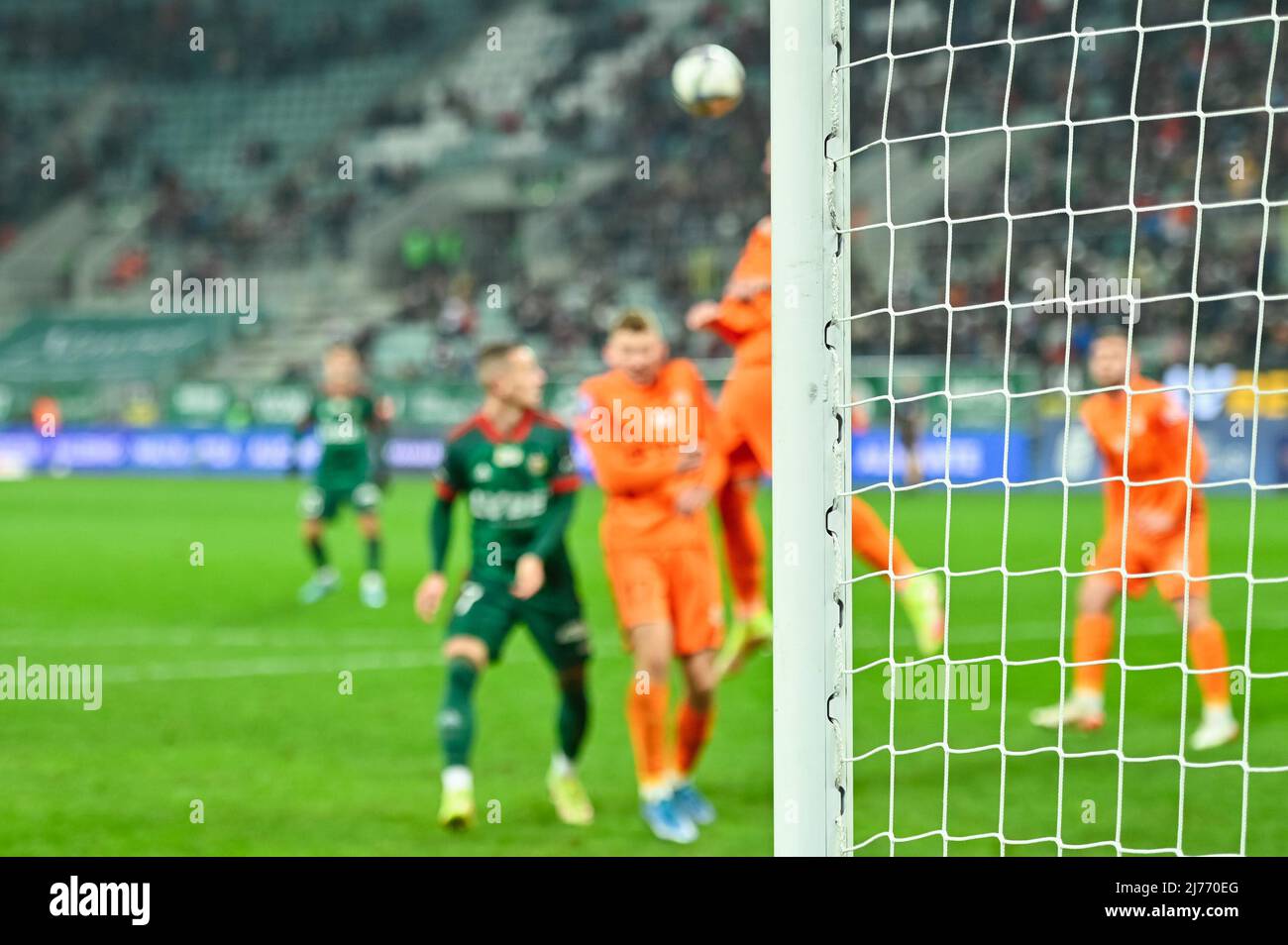 Soccer goal post and soccer match in the background Stock Photo - Alamy