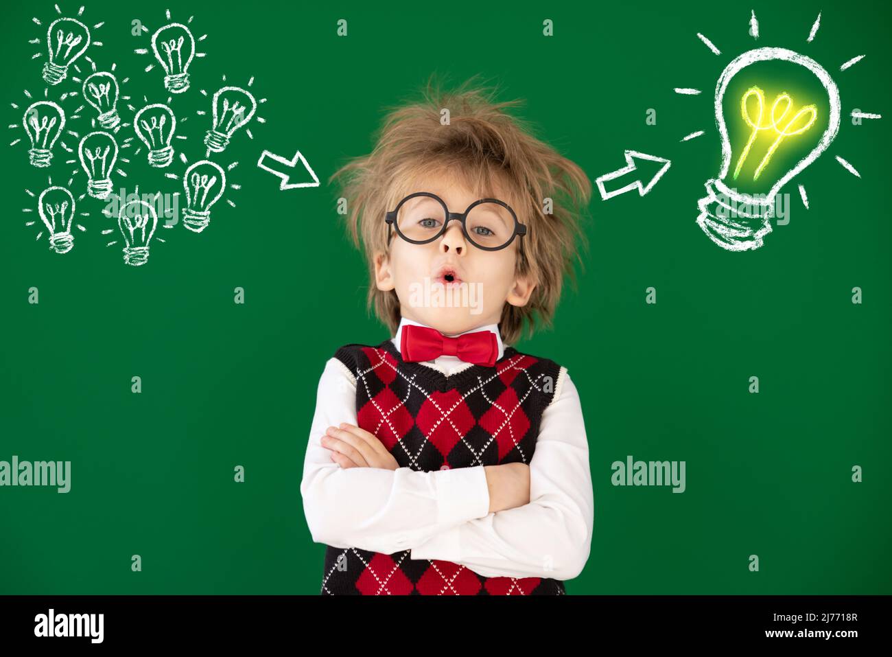 Funny child student in class. Happy kid against green chalkboard ...