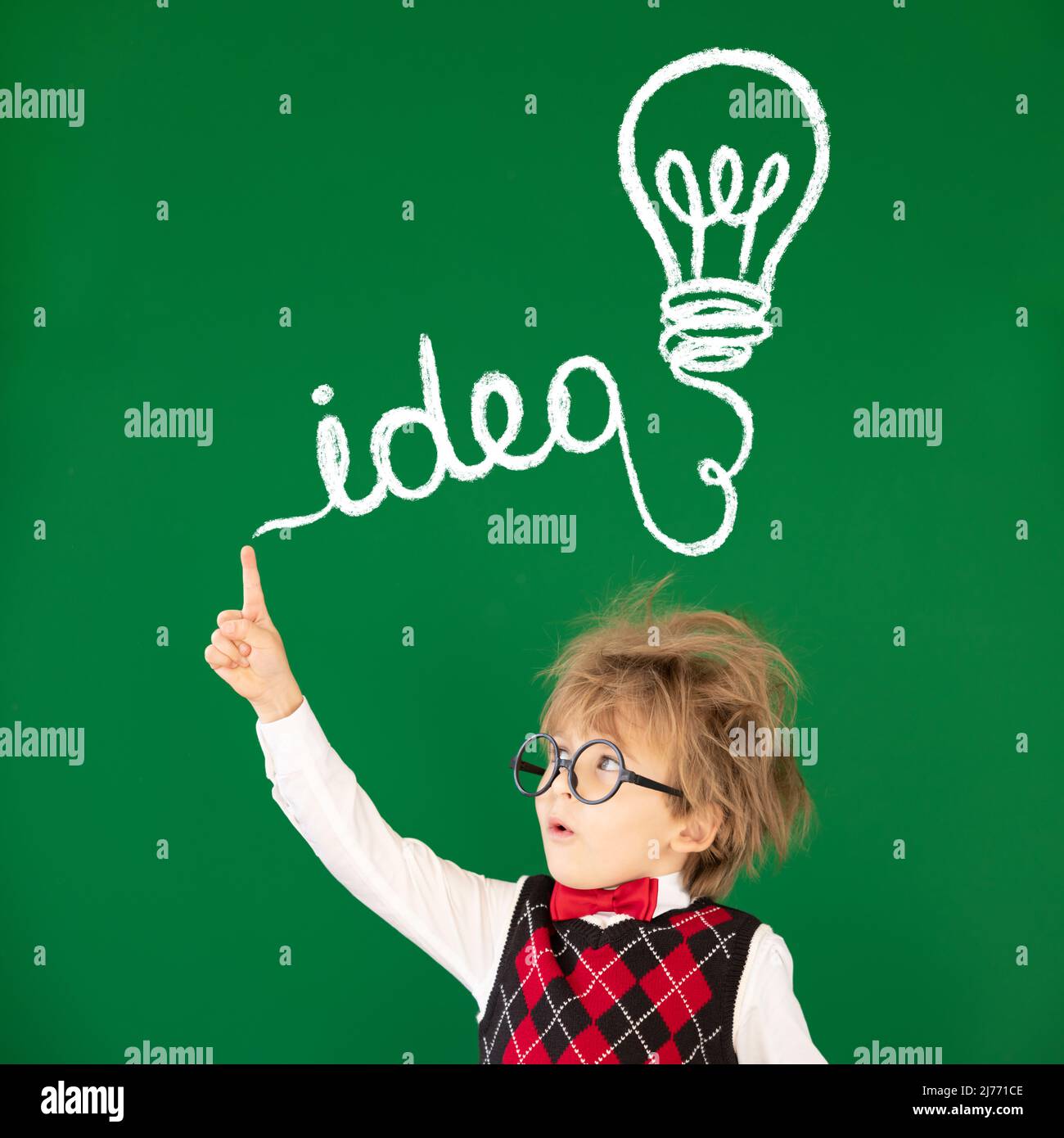 Funny child student in class. Happy kid against green chalkboard ...