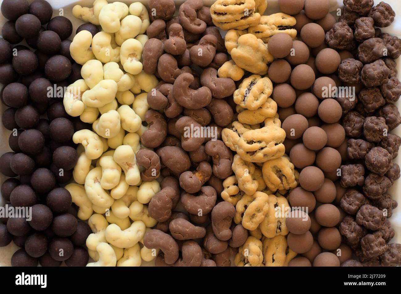 Six types of chocolate covered nuts in vertical rows Stock Photo - Alamy
