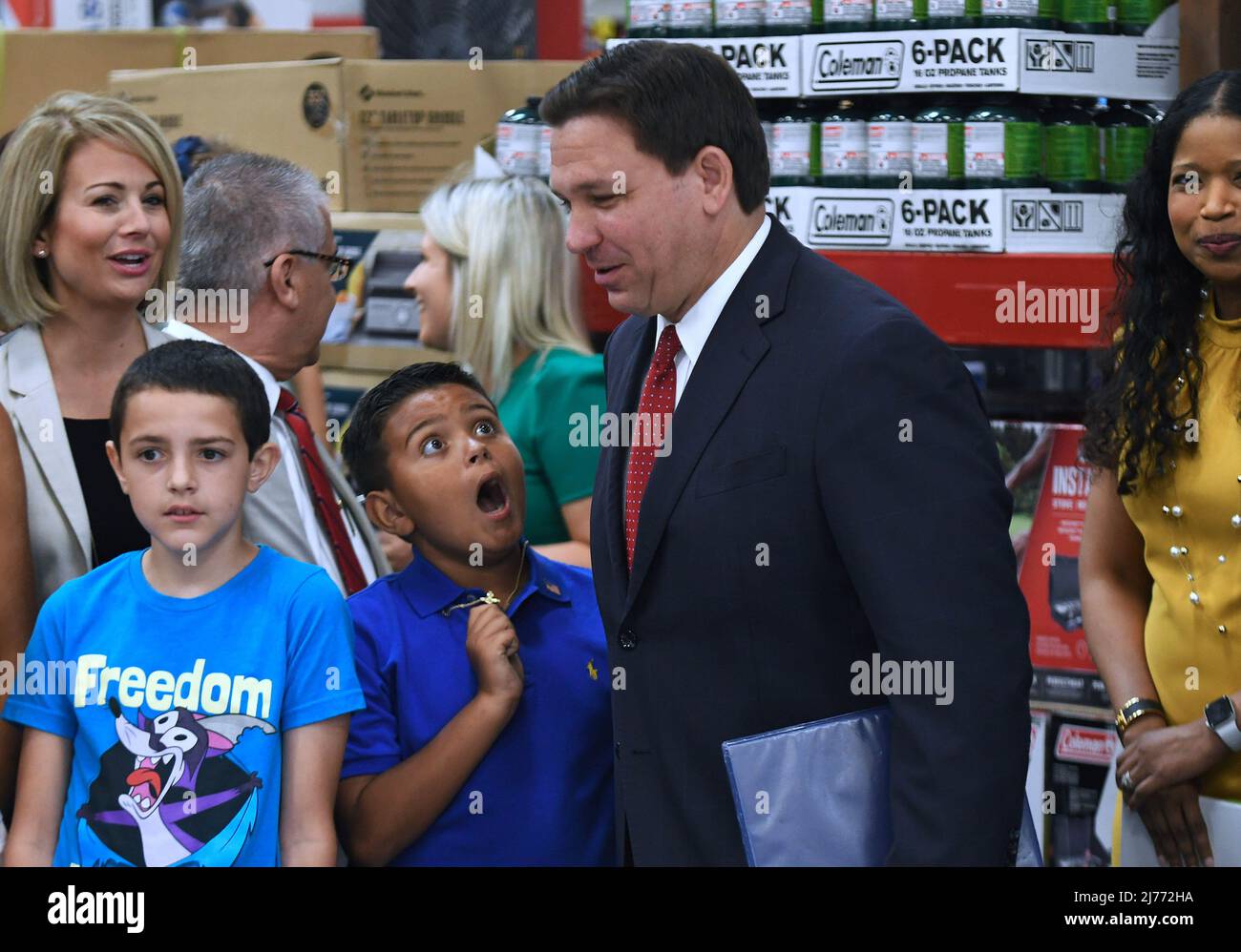 A young boy reacts as Florida Governor Ron DeSantis arrives to speak at ...