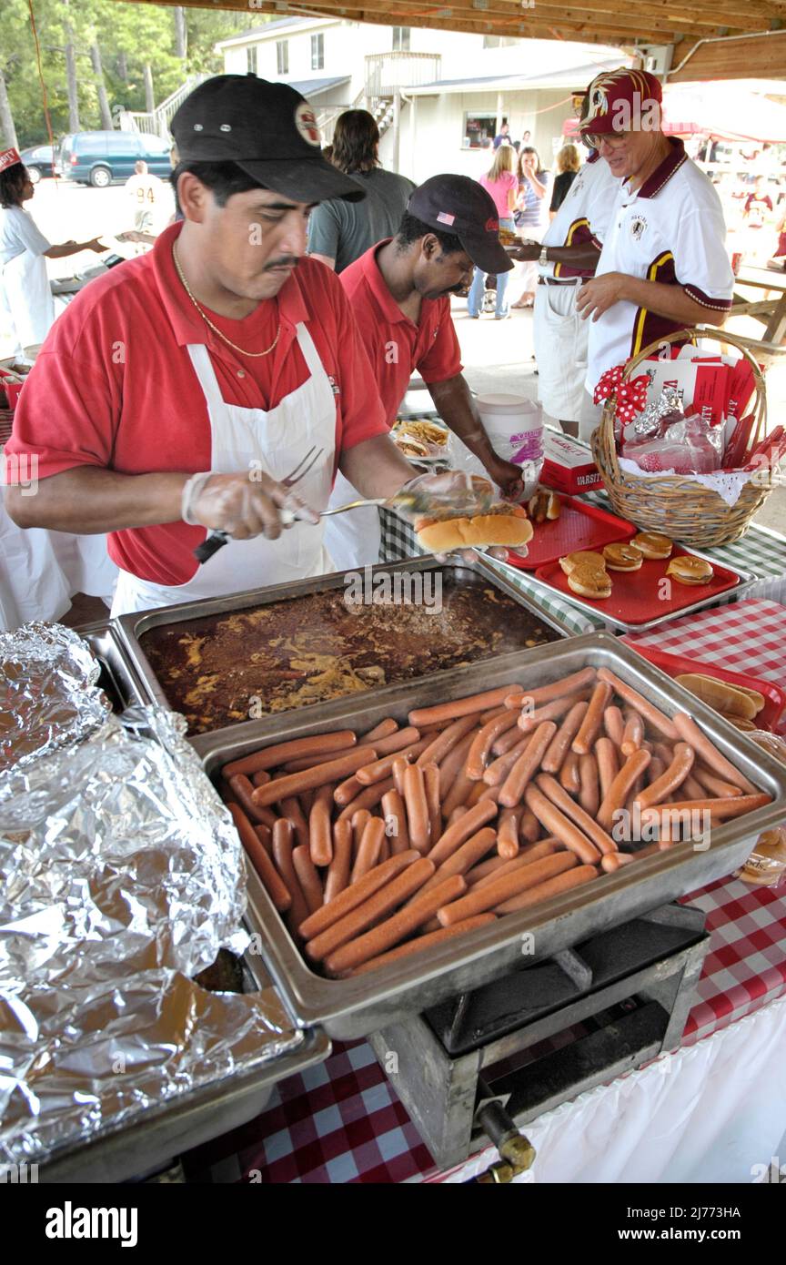 face of Fast food Hispanic cook boiling and making hot dogs, whinnies ...