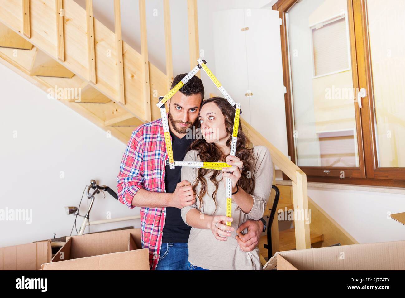 young couple moves into new home Stock Photo - Alamy