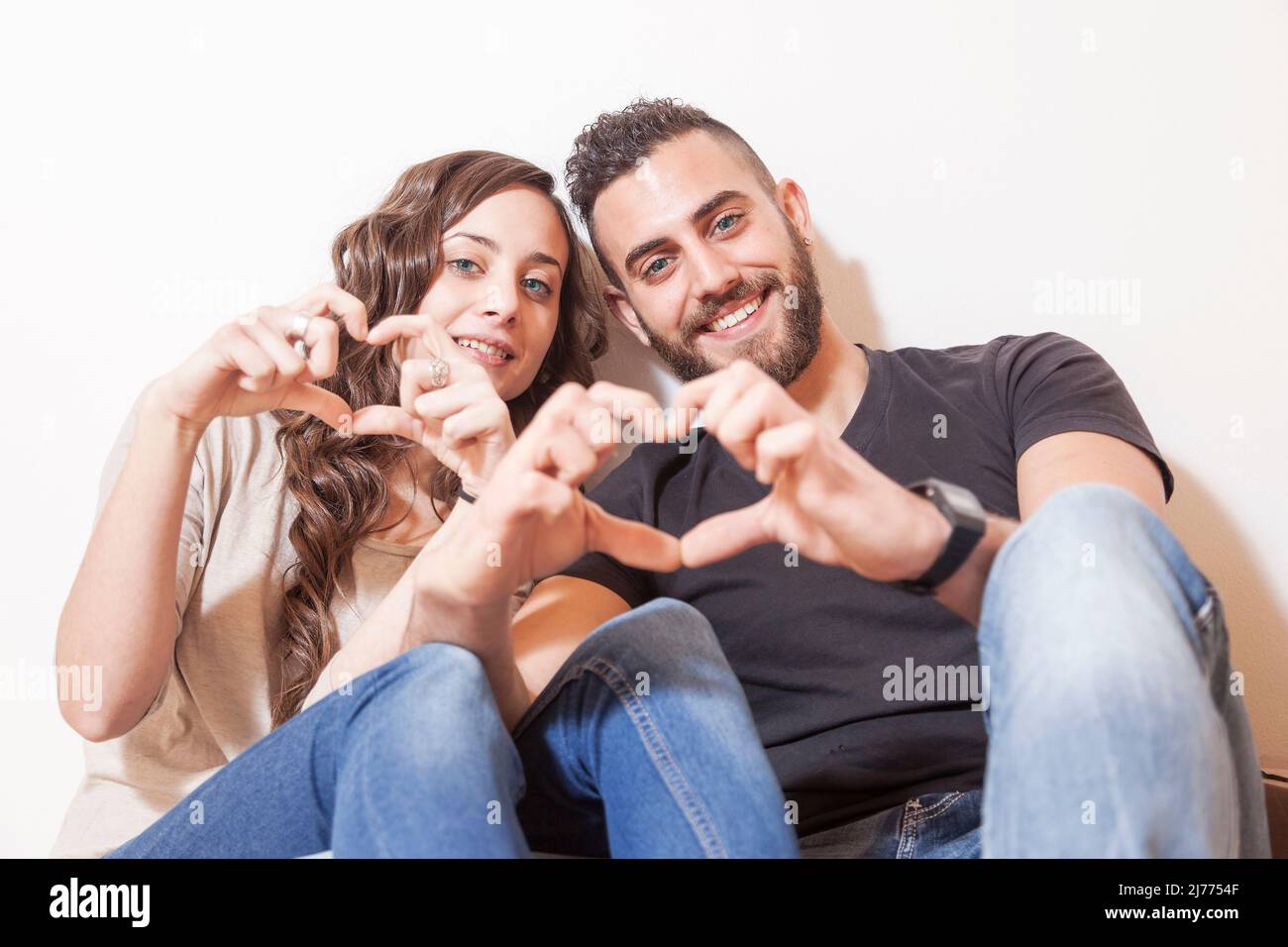 pretty young couple makes heart sign with his hands Stock Photo - Alamy