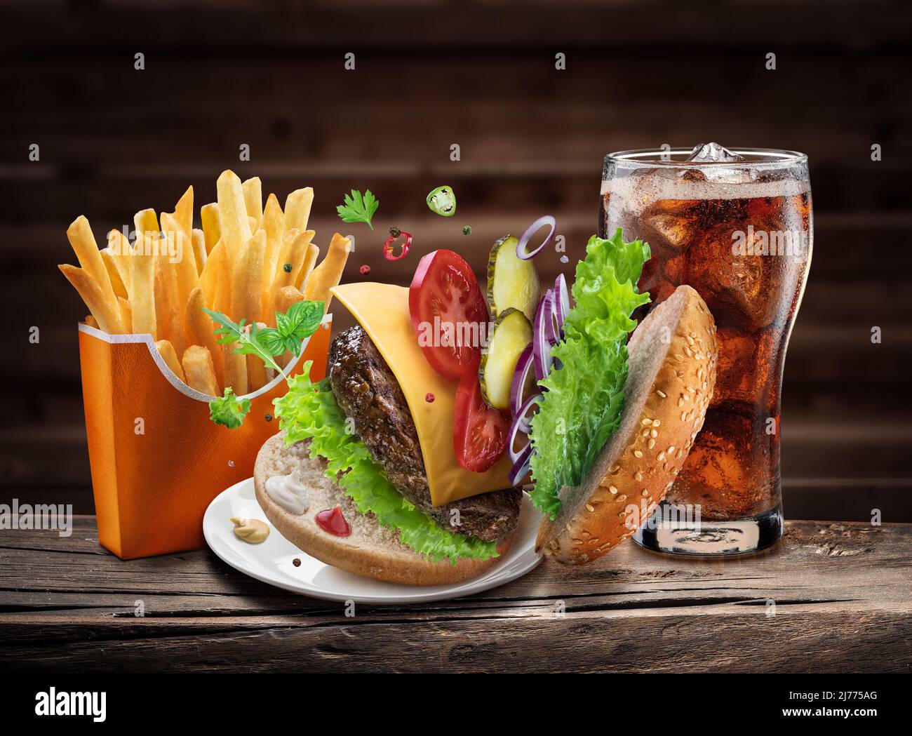 Delicious cheeseburger with cola and potato fries on the wooden ...