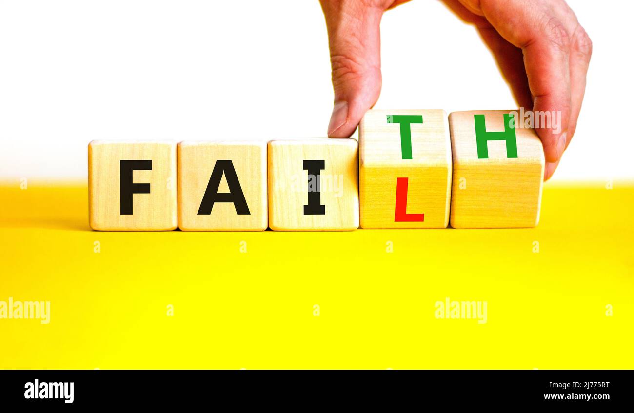 Faith instead fail symbol. Businessman turns wooden cubes and changes ...