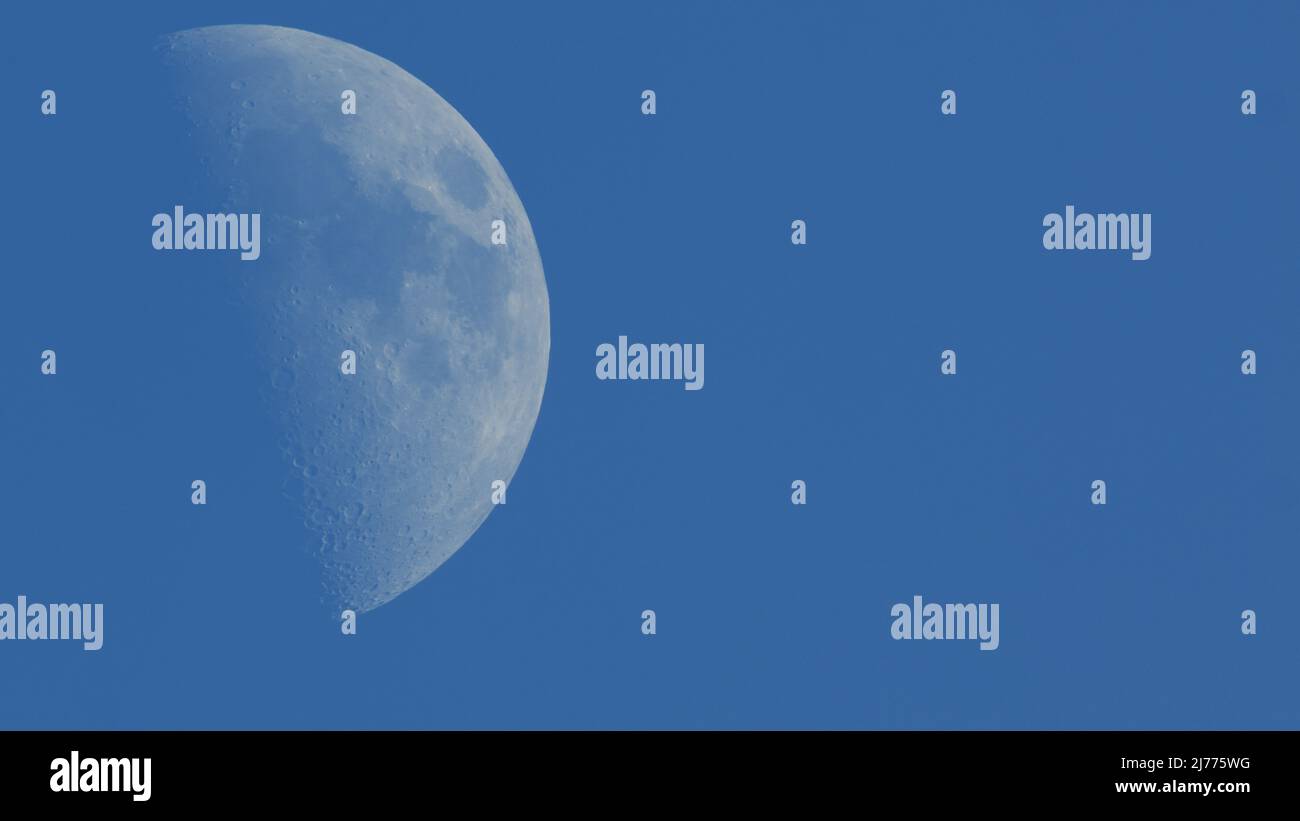Photograph of Moon in the first quarter lunar phase Stock Photo - Alamy