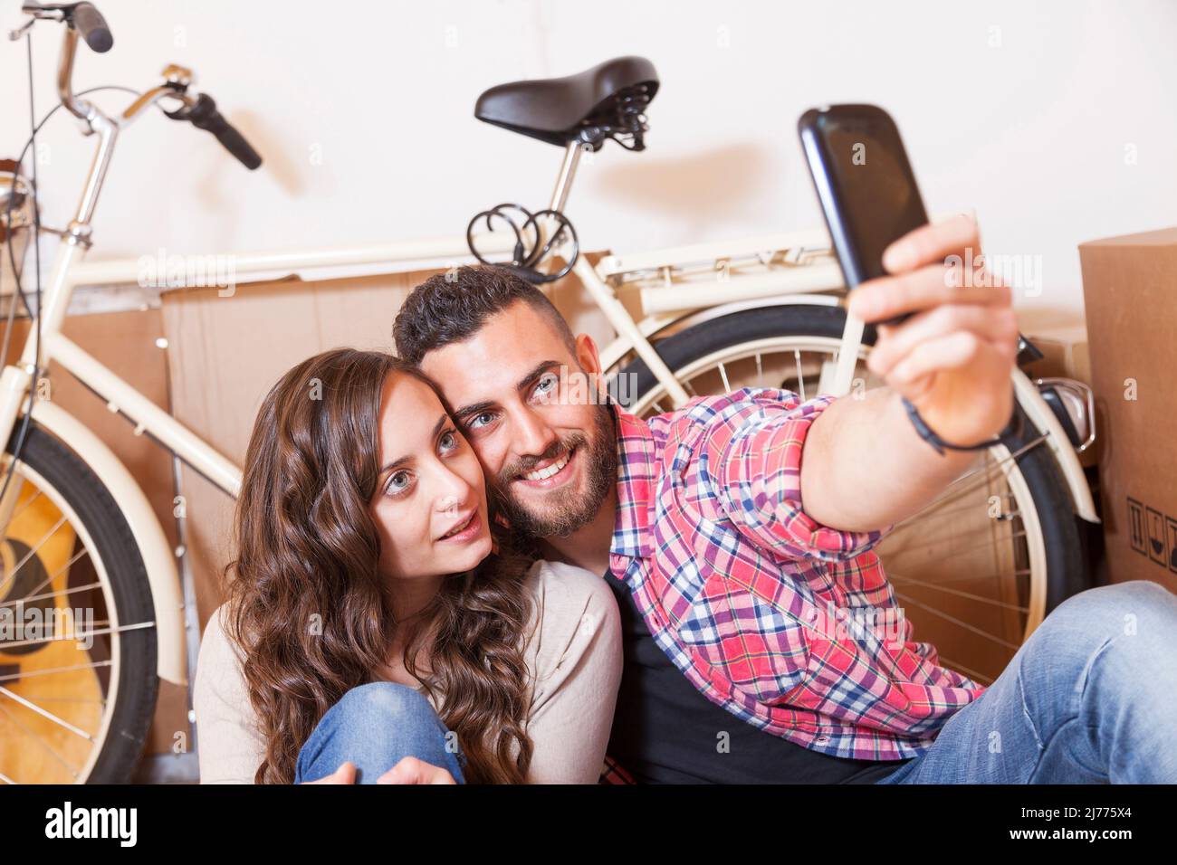 pretty young couple take a selfie after moving Stock Photo - Alamy