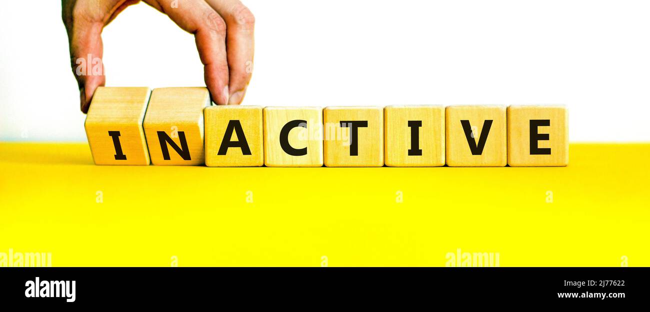 Active or inactive symbol. Businessman turns wooden cubes and changes ...