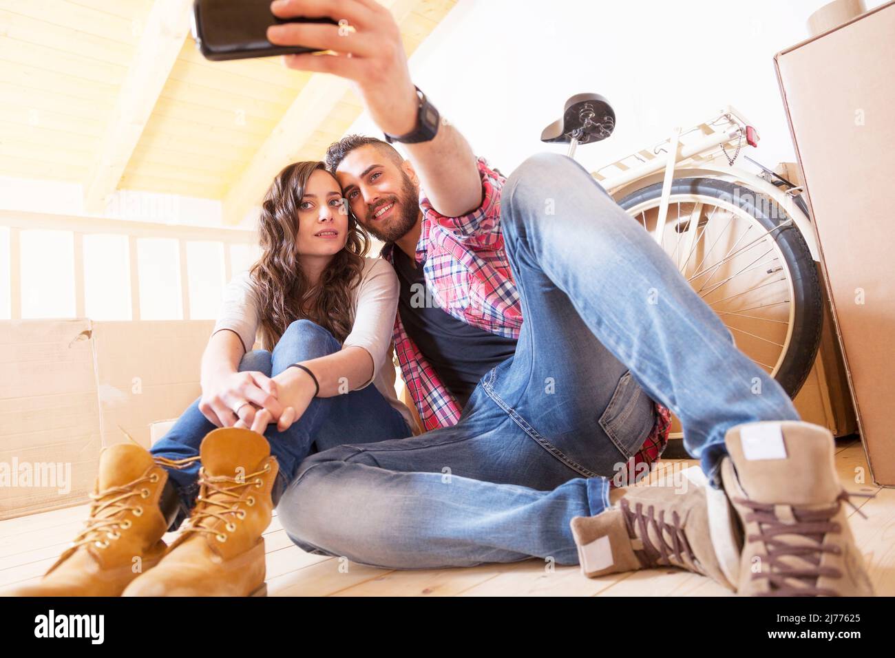 pretty young couple take a selfie after moving Stock Photo - Alamy