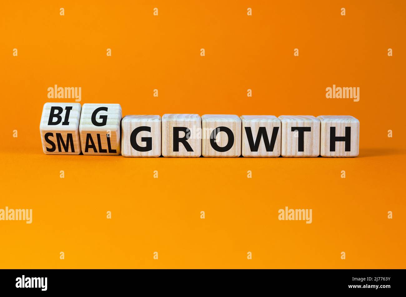 Big or small growth symbol. Turned wooden cubes and changed concept ...