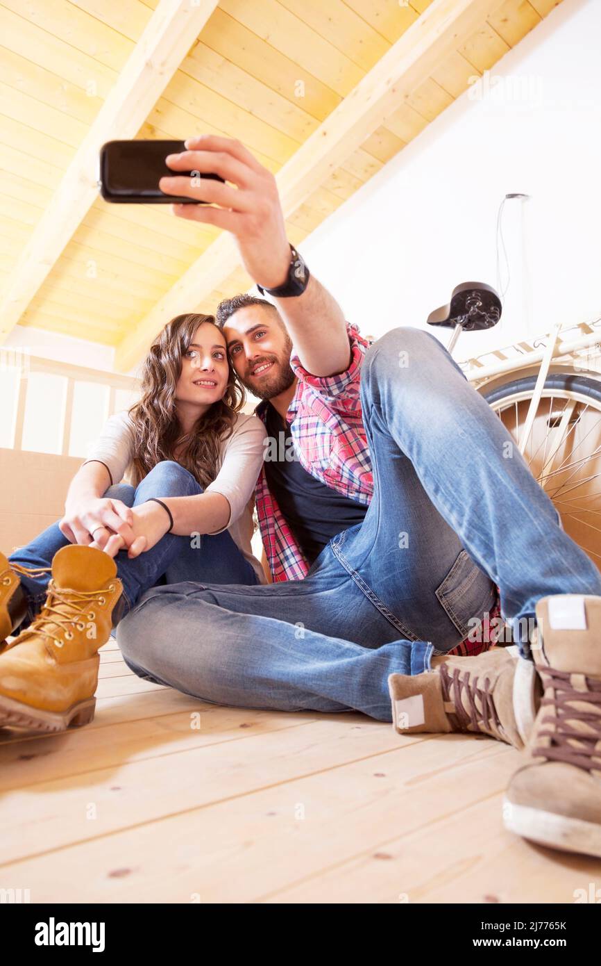 pretty young couple take a selfie after moving Stock Photo - Alamy