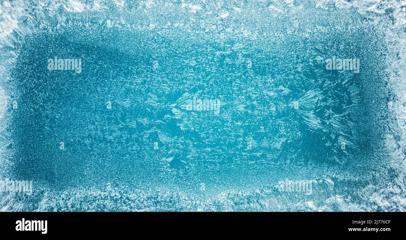 Frost patterns on frozen winter window as a symbol of Christmas wonder ...