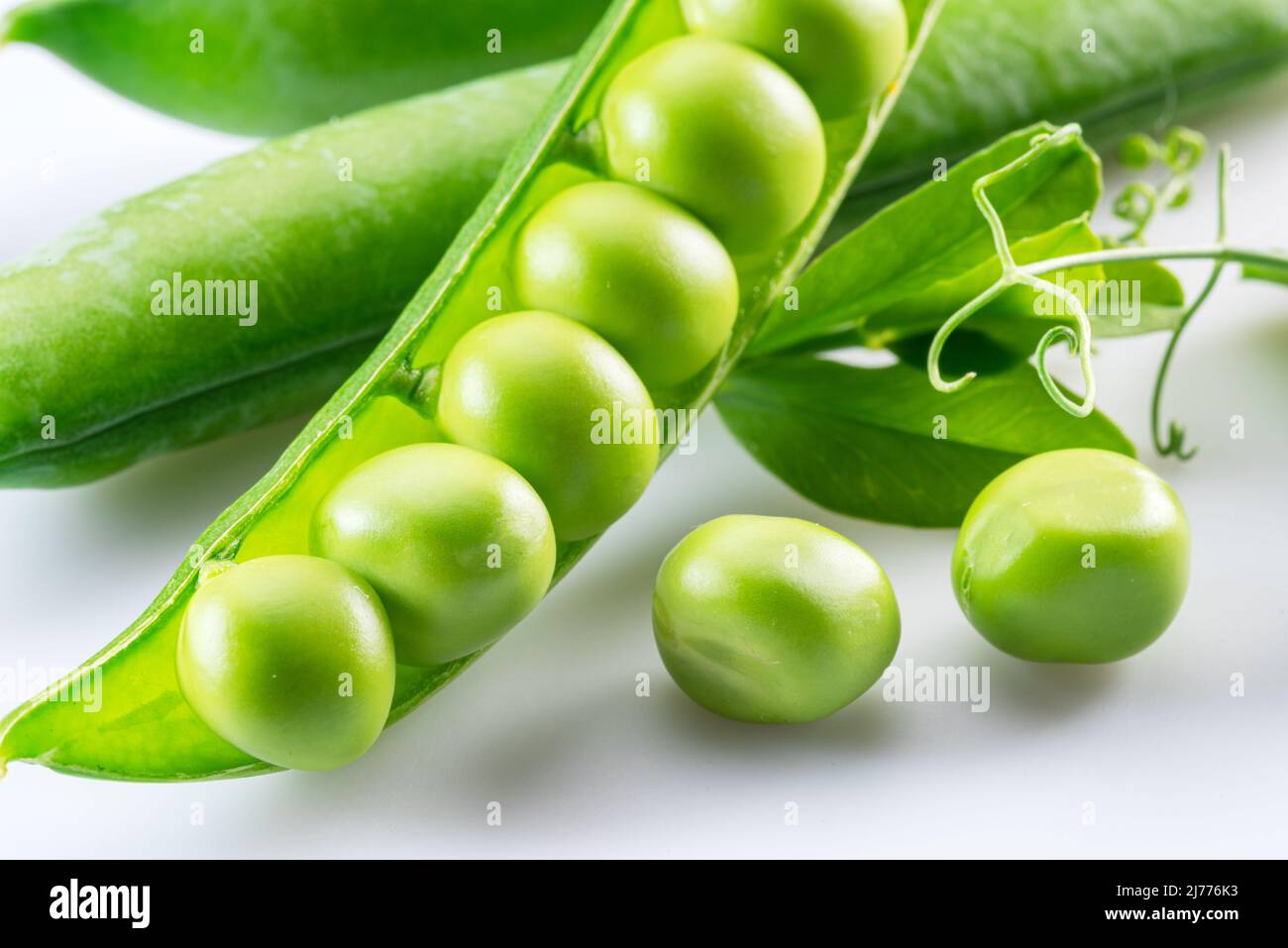 Perfect green peas in pod isolated on white background Stock Photo - Alamy