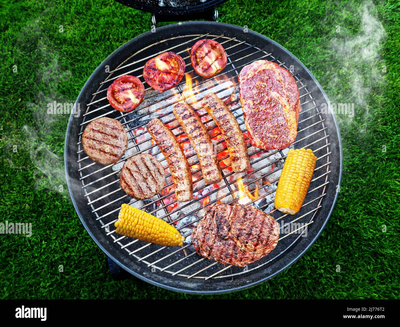 Grilled meat, sausages and vegetables on open grill grate. Conceptual ...