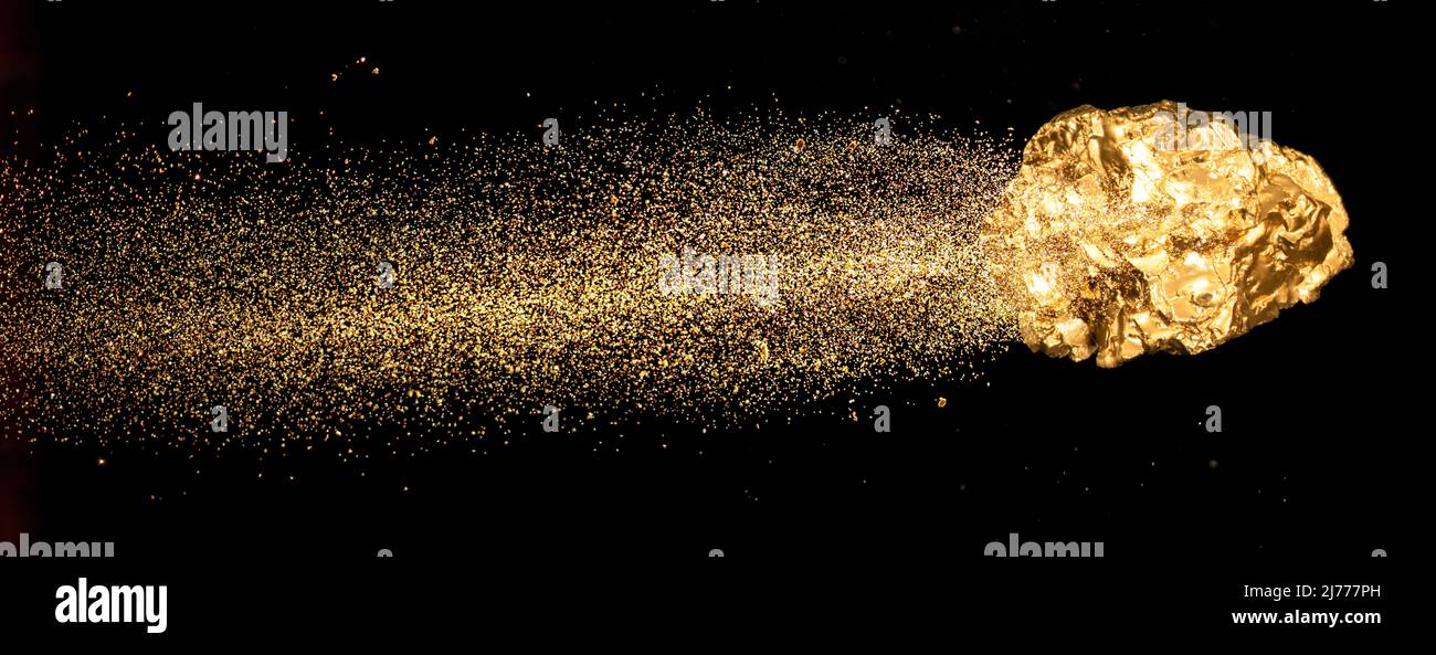 Piece of gold or golden nugget with visible gold shining comet tail ath ...