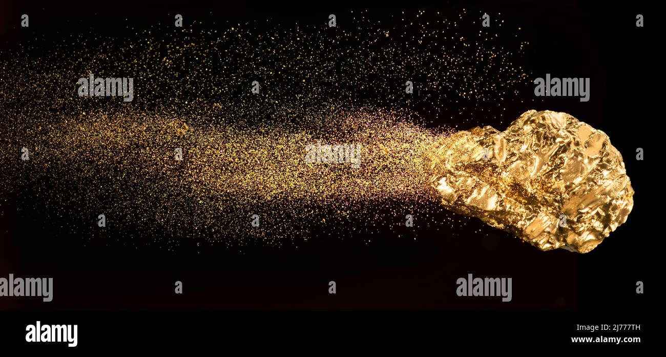 Piece of gold or golden nugget with visible gold shining comet tail ath ...