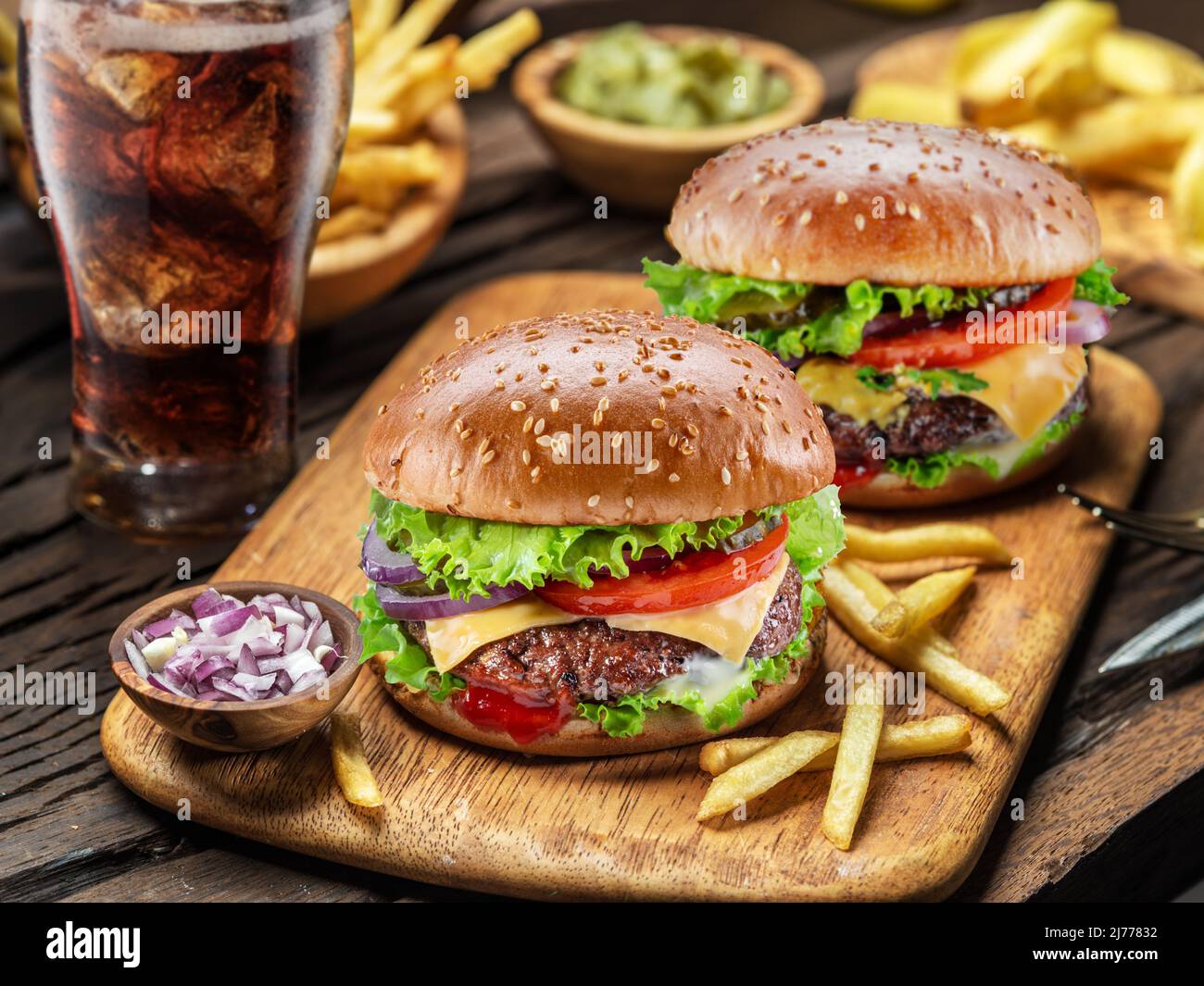 Delicious cheeseburger with cola and potato fries on the wooden ...