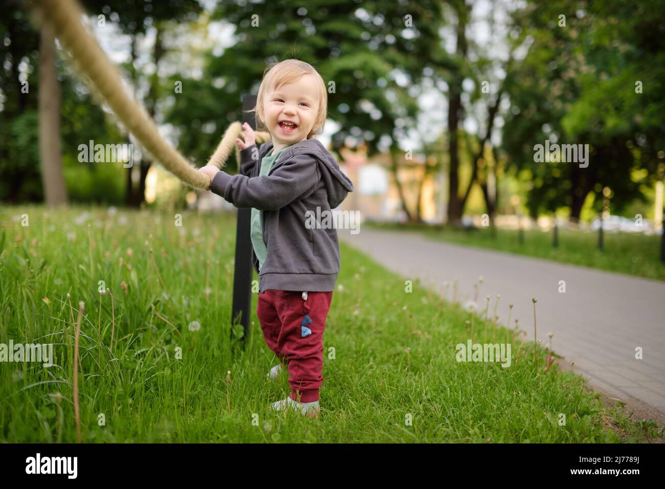 Funny toddler boy having fun outdoors on sunny summer day. Child ...