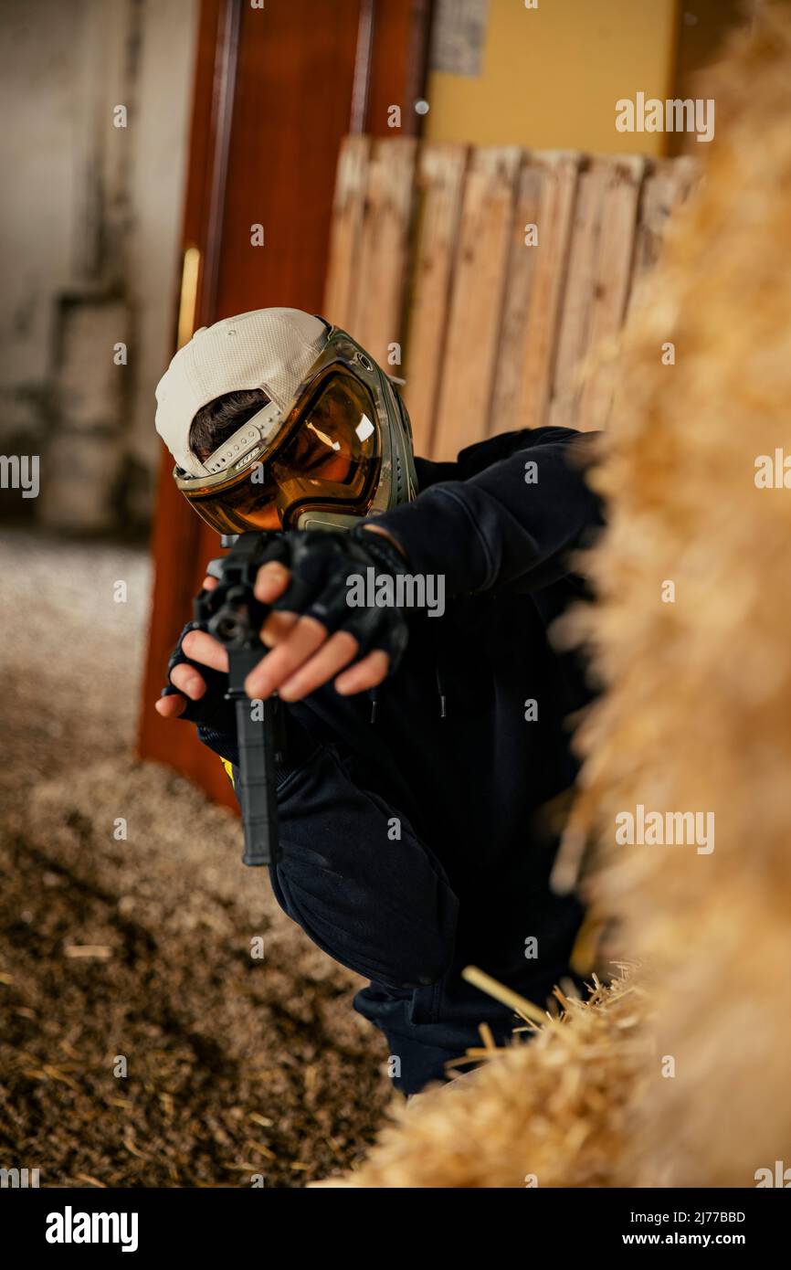 Soldier aiming airsoft gun during tactical game Stock Photo - Alamy
