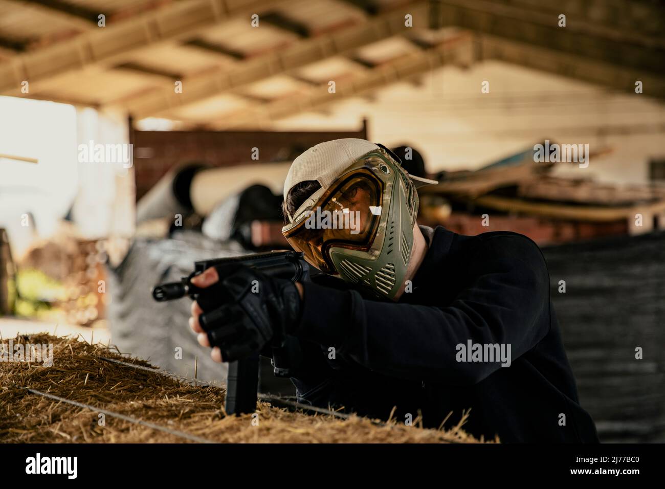 Soldier aiming airsoft gun during tactical game Stock Photo - Alamy