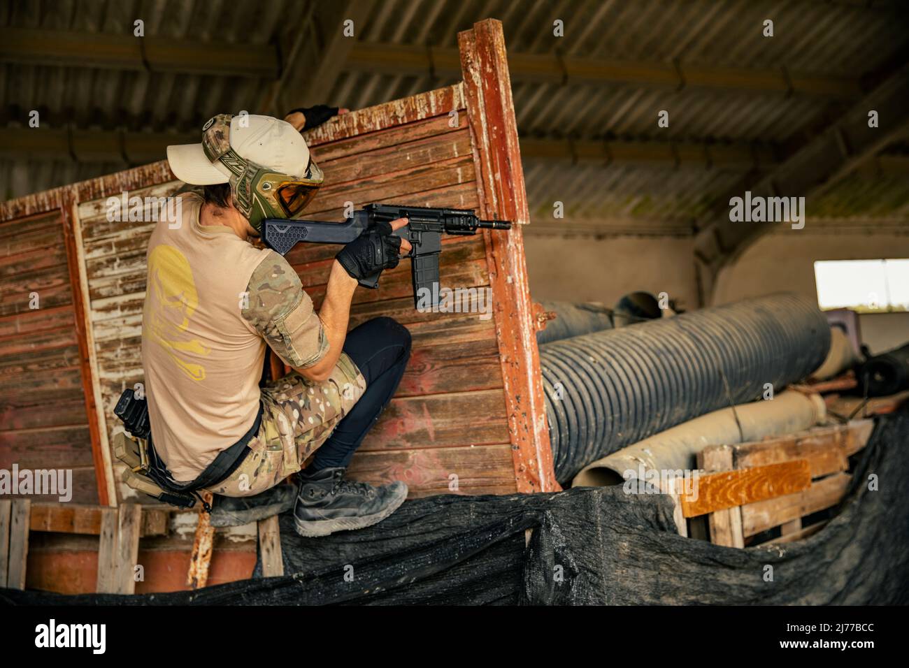 Soldier aiming airsoft gun during tactical game Stock Photo - Alamy