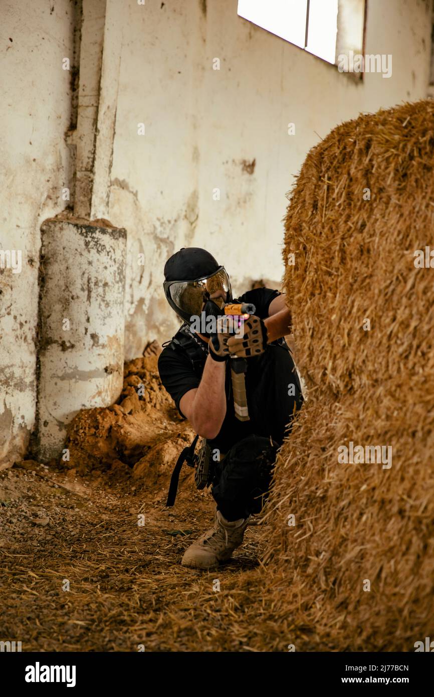 Soldier aiming airsoft gun during tactical game Stock Photo - Alamy