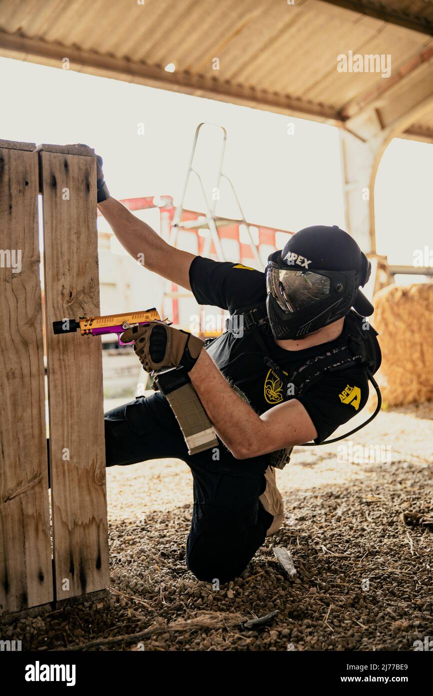 Soldier aiming airsoft gun during tactical game Stock Photo - Alamy
