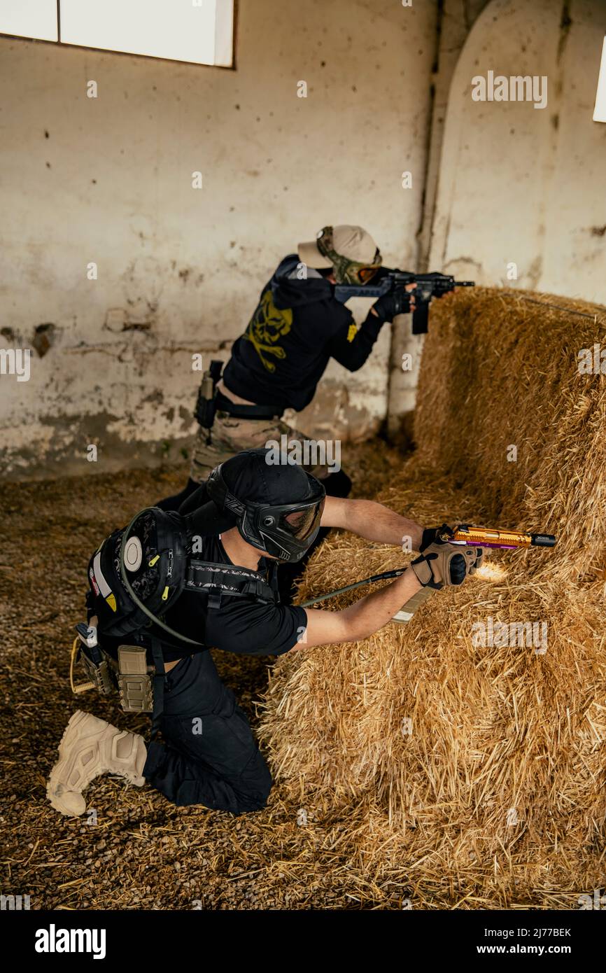 Soldiers aiming airsoft gun during tactical game Stock Photo - Alamy