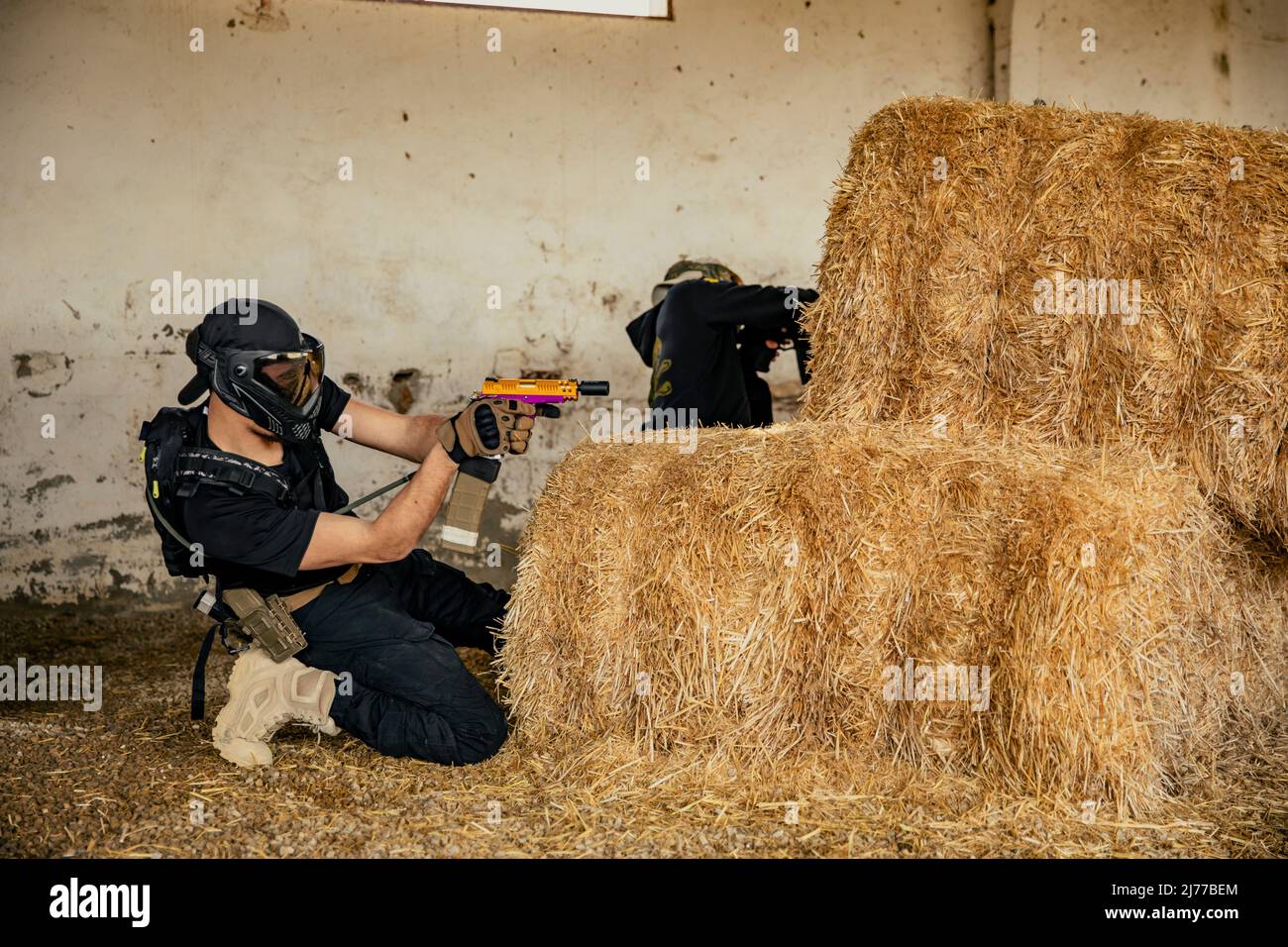 Soldiers aiming airsoft gun during tactical game Stock Photo - Alamy