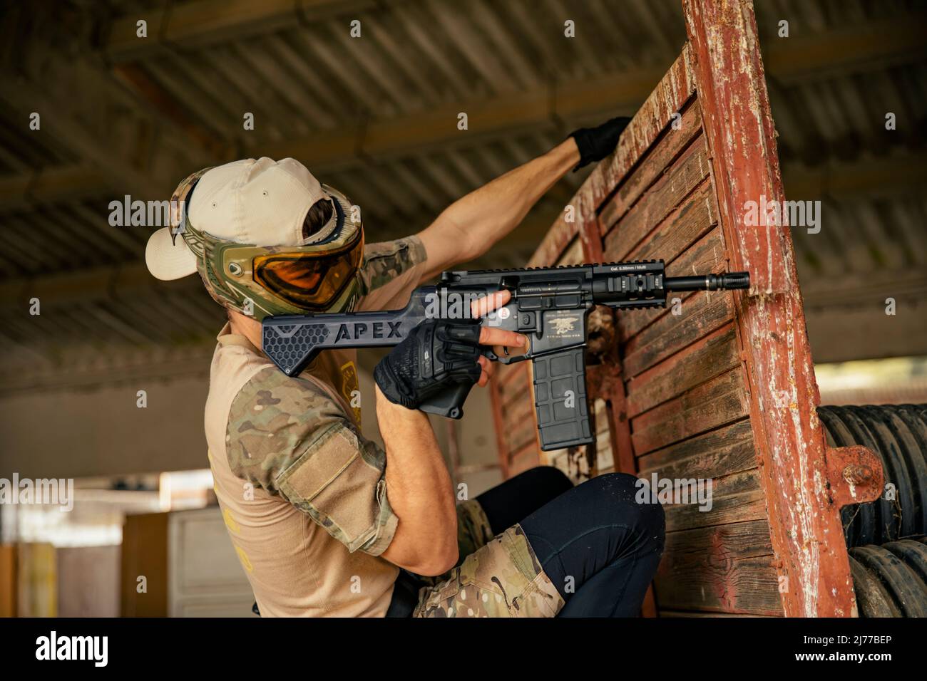 Soldier aiming airsoft gun during tactical game Stock Photo - Alamy