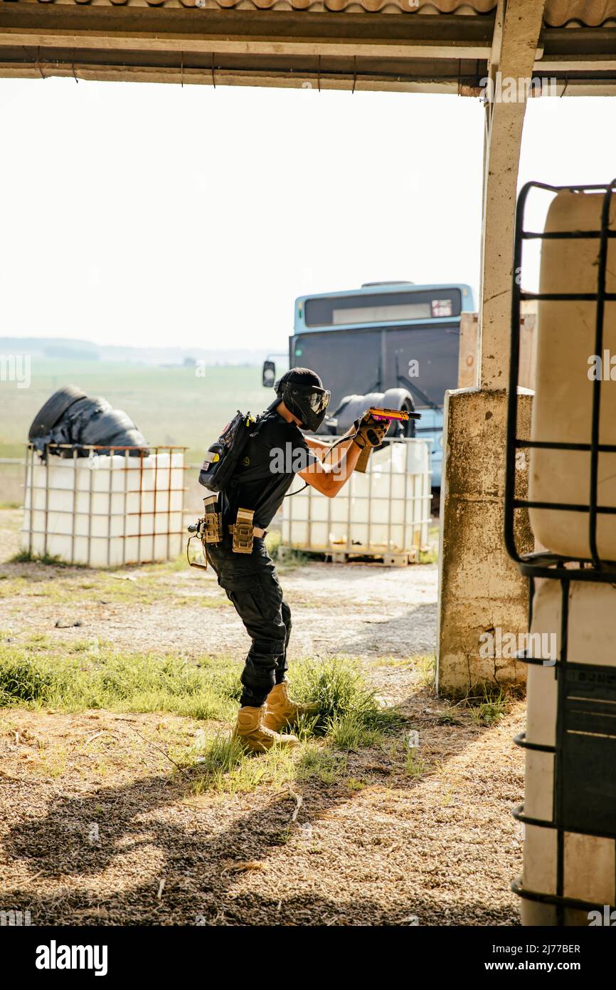 Soldier aiming airsoft gun during tactical game Stock Photo - Alamy