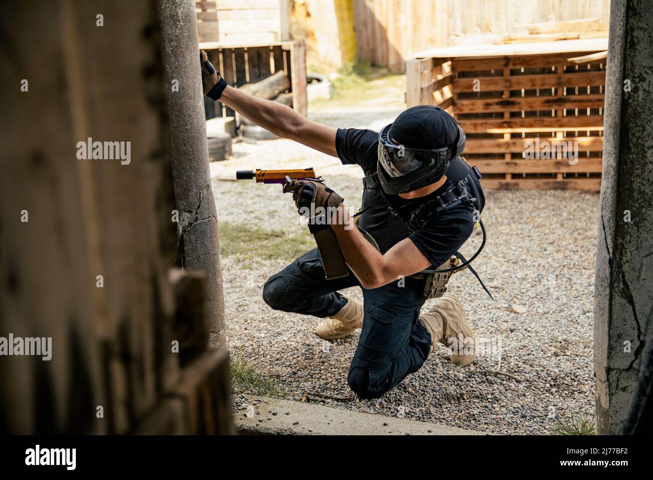 Soldier aiming airsoft gun during tactical game Stock Photo - Alamy