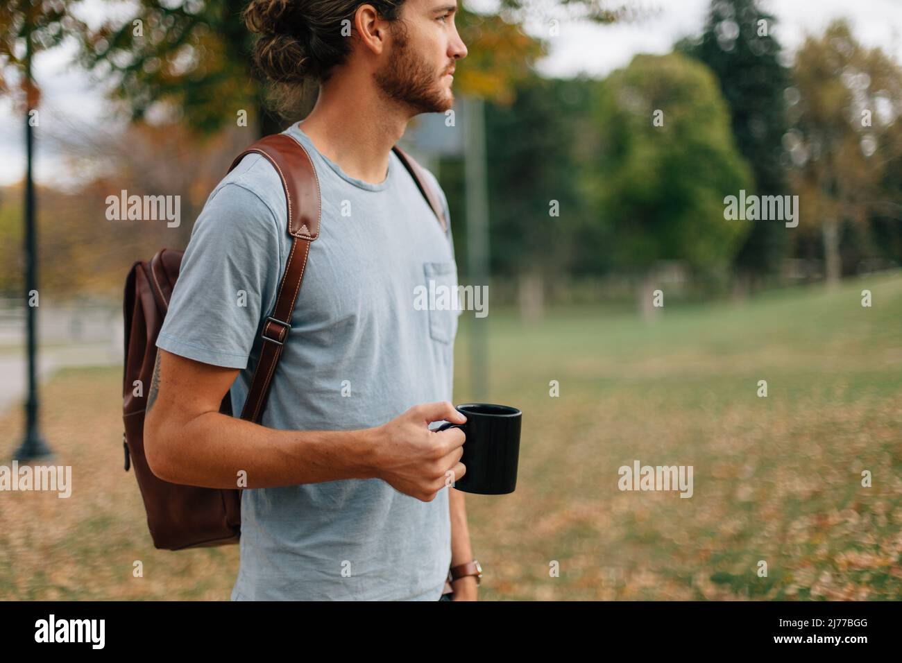 Man wearing backpack standing hi-res stock photography and images - Alamy