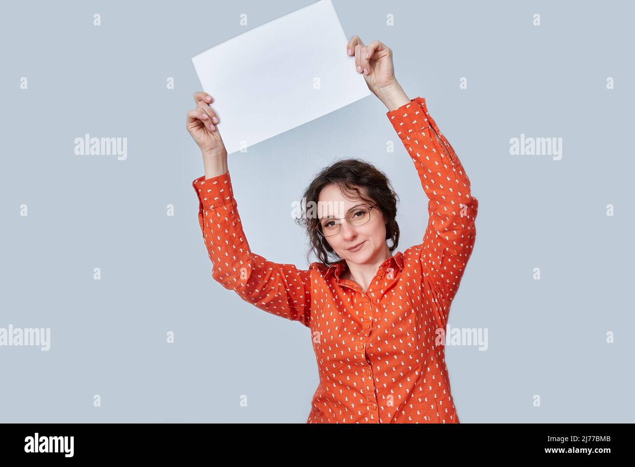 A middle-aged woman with a white paper in her hands Stock Photo - Alamy