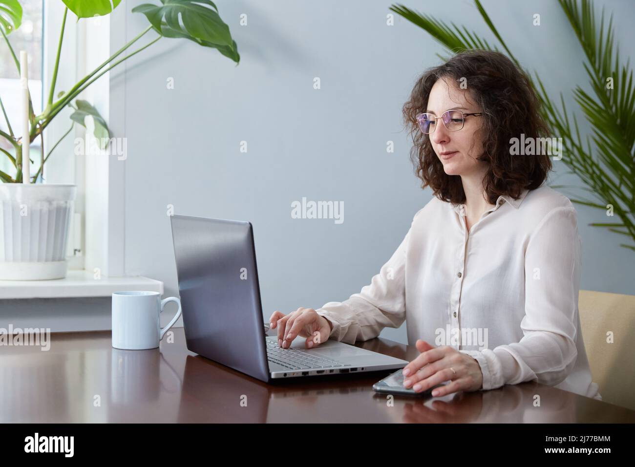 Woman sitting at desk cold hi-res stock photography and images - Alamy